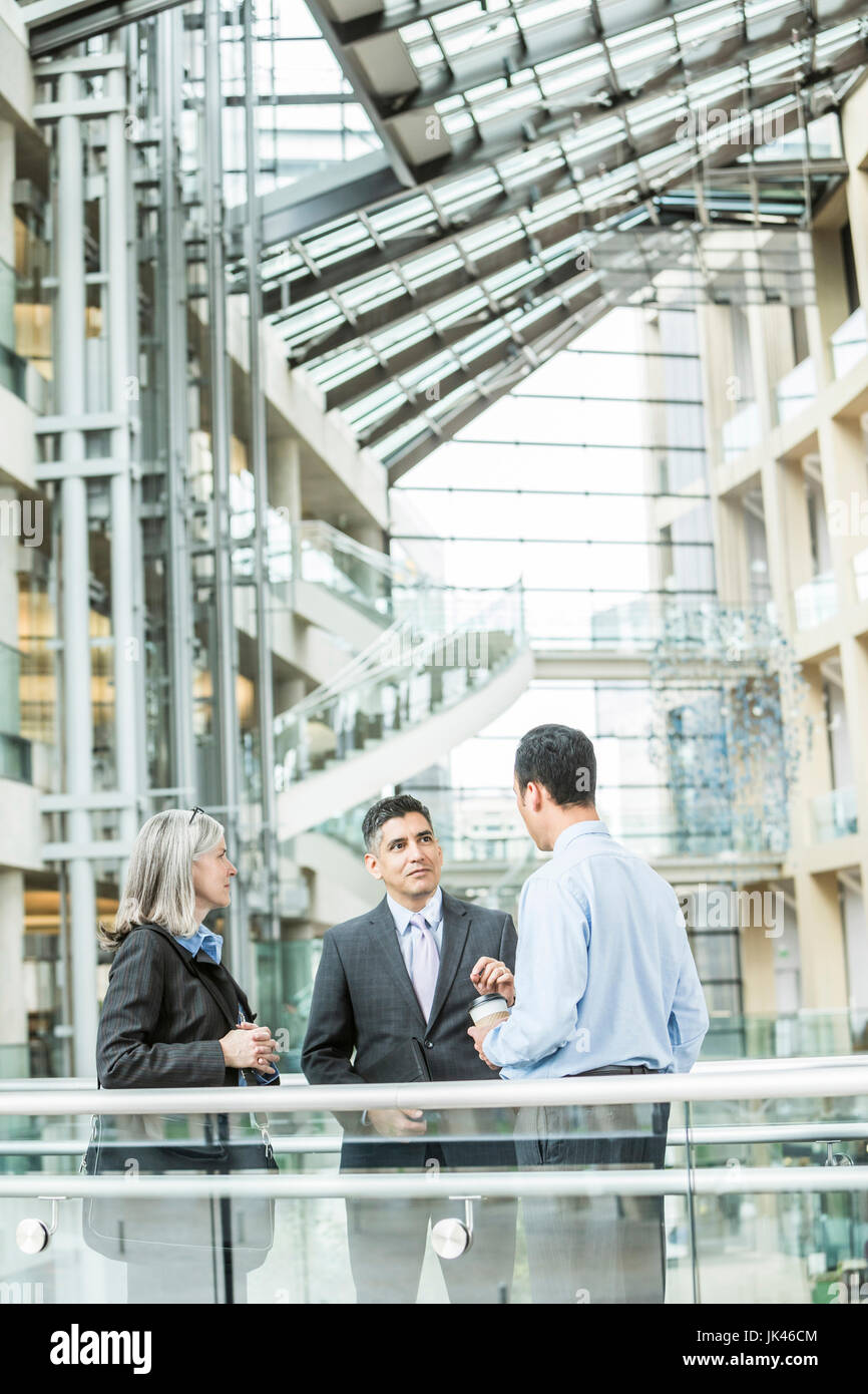 Serious business people talking in lobby Stock Photo - Alamy