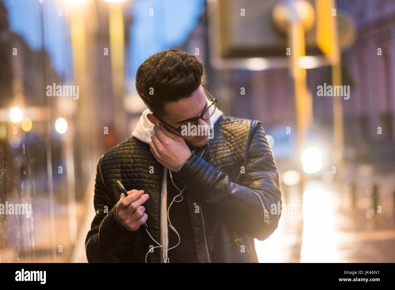 Man holding cell phone ear hi-res stock photography and images - Alamy