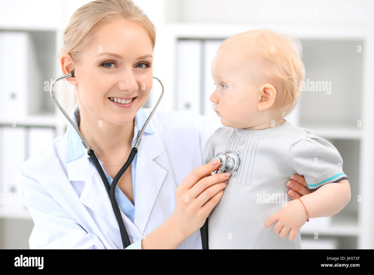 Pediatrician is taking care of baby in hospital. Little girl is being ...