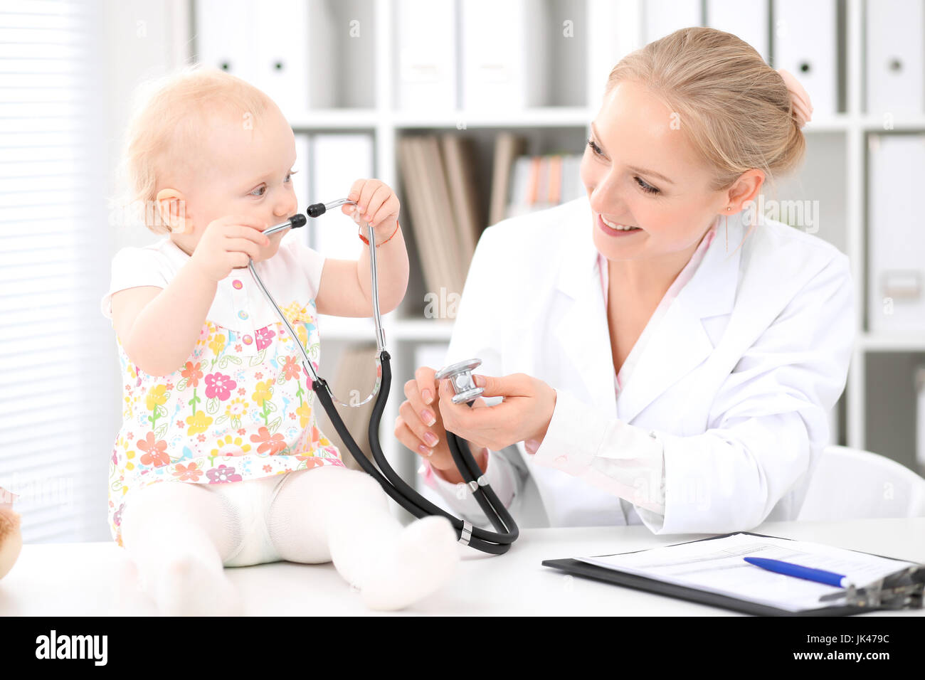 Pediatrician is taking care of baby in hospital. Little girl is being ...