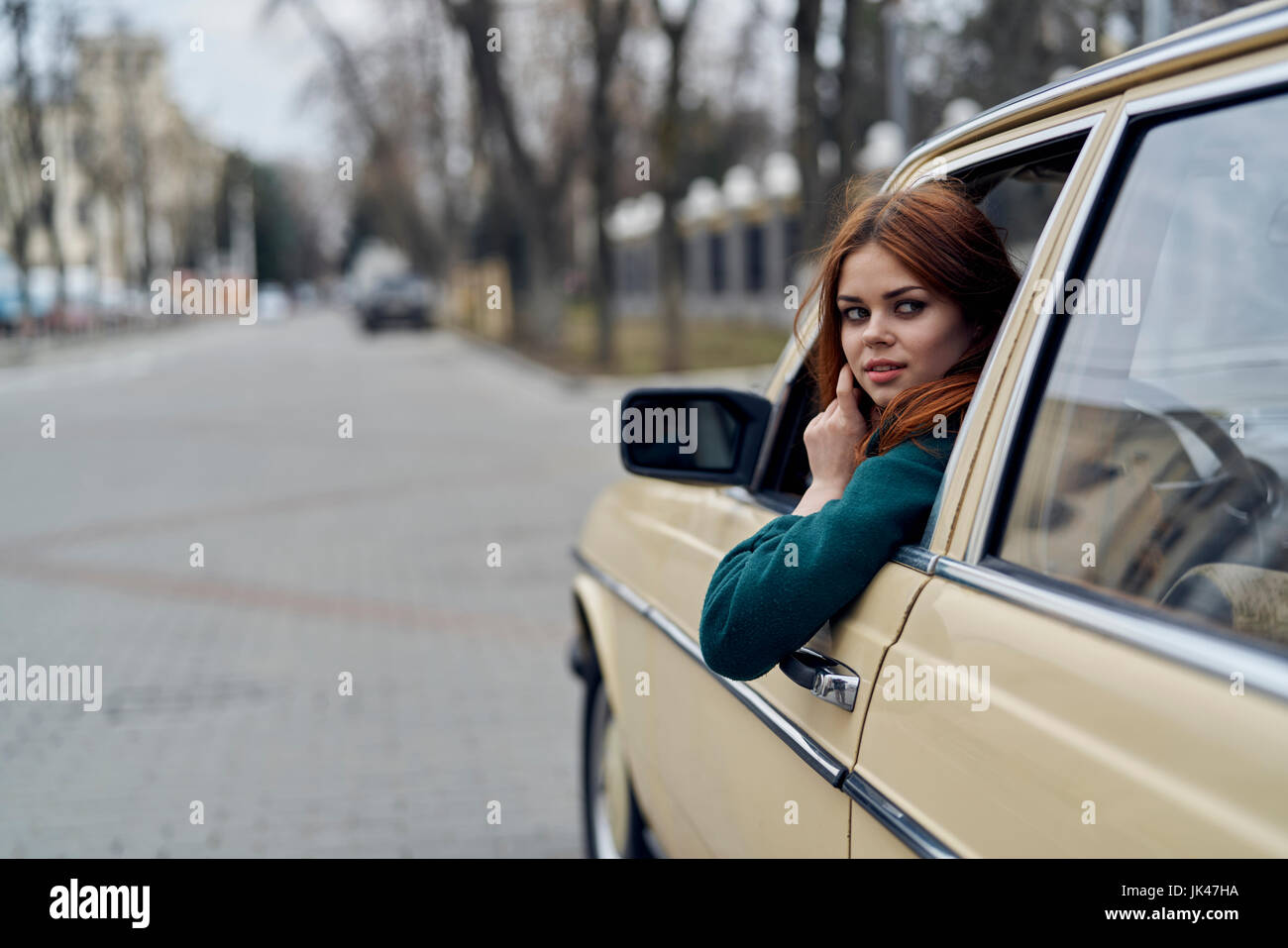 Caucasian woman driving car looking over shoulder Stock Photo - Alamy