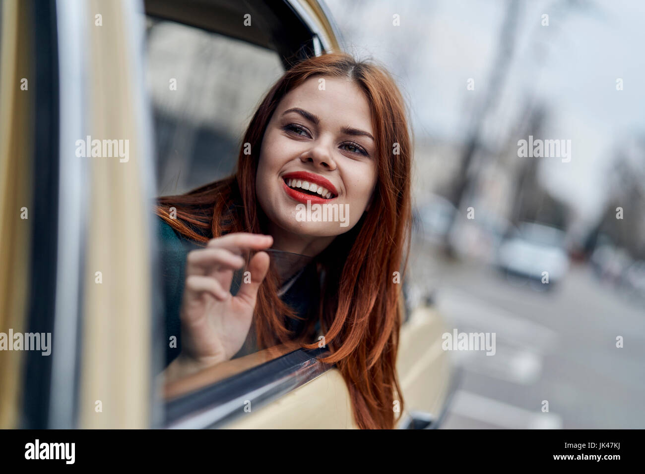 Smiling Caucasian woman in back seat of car Stock Photo - Alamy
