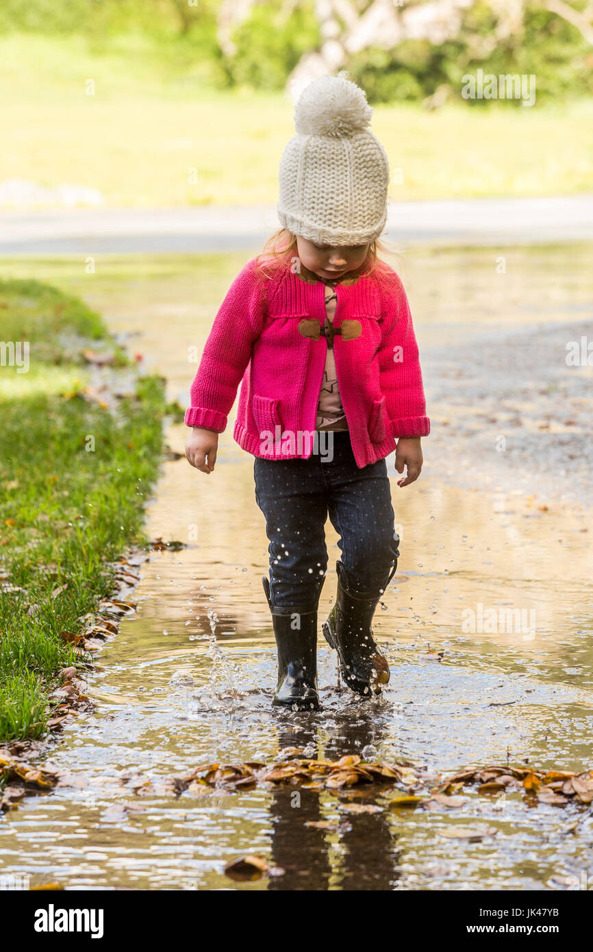 Kid splashing puddle sunny hi-res stock photography and images - Alamy