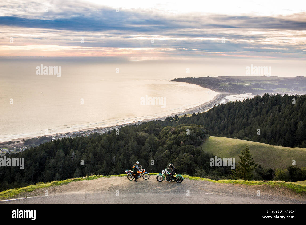 People on motorcycles at edge of cliff near ocean Stock Photo - Alamy