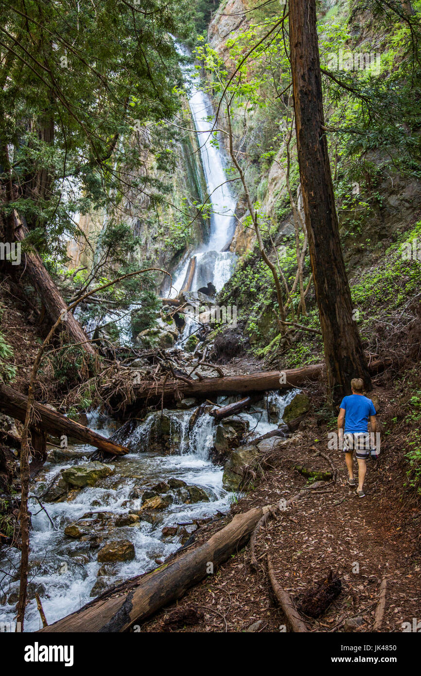 Caucasian man walking near waterfall in forest Stock Photo - Alamy