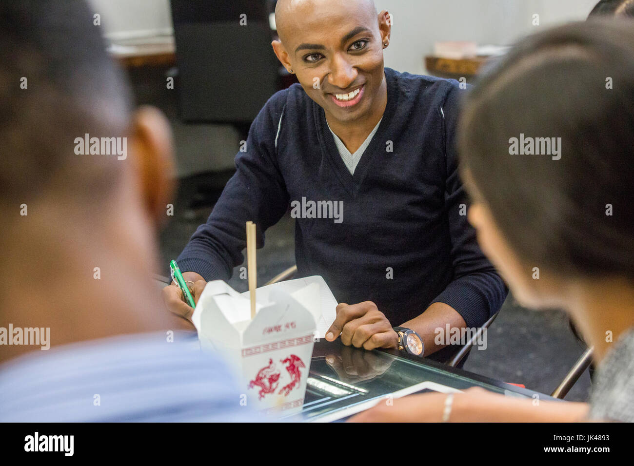 Business people eating food during meeting Stock Photo - Alamy