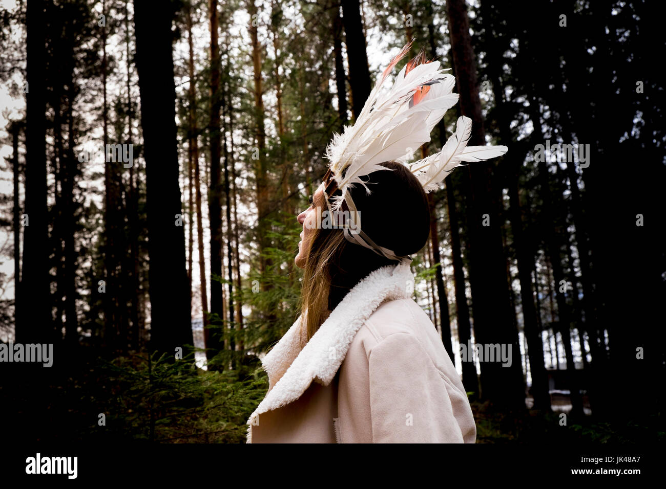 Caucasian woman wearing headdress in forest Stock Photo - Alamy
