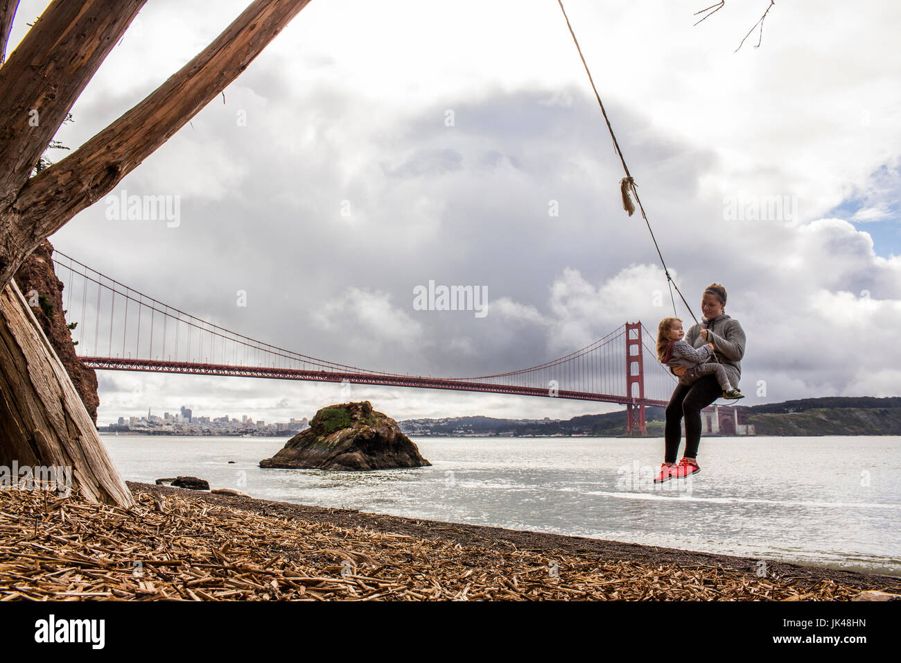 Child and adult and swing and tree hi-res stock photography and images ...