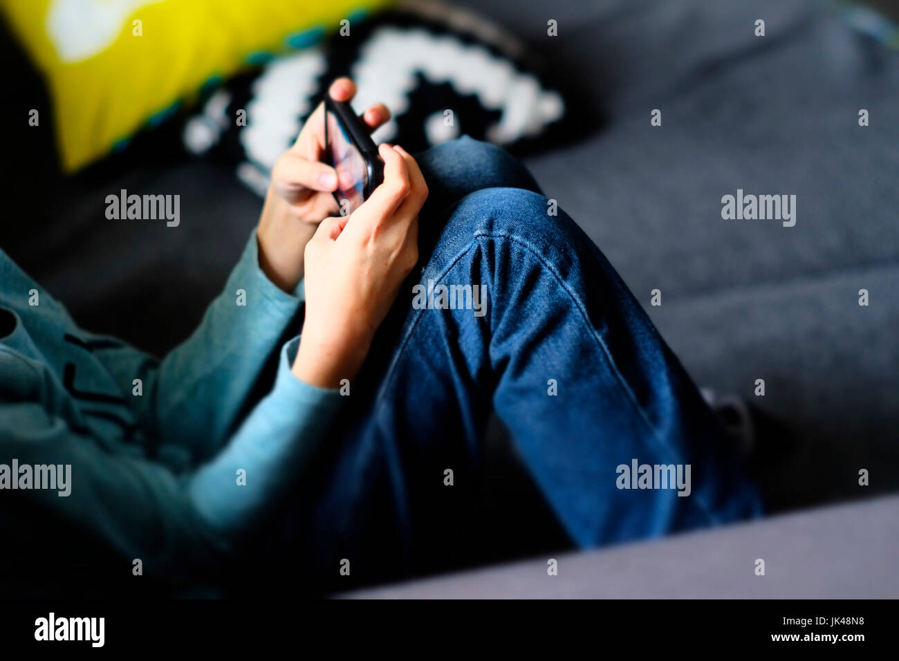 Close up of Caucasian boy playing with cell phone Stock Photo - Alamy