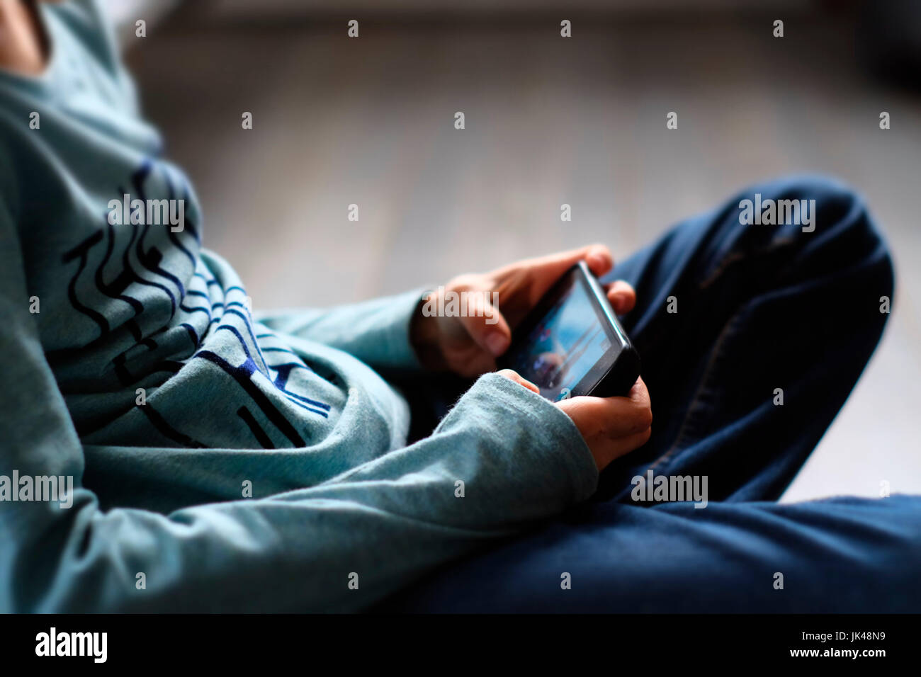 Close up of Caucasian boy playing with cell phone Stock Photo - Alamy