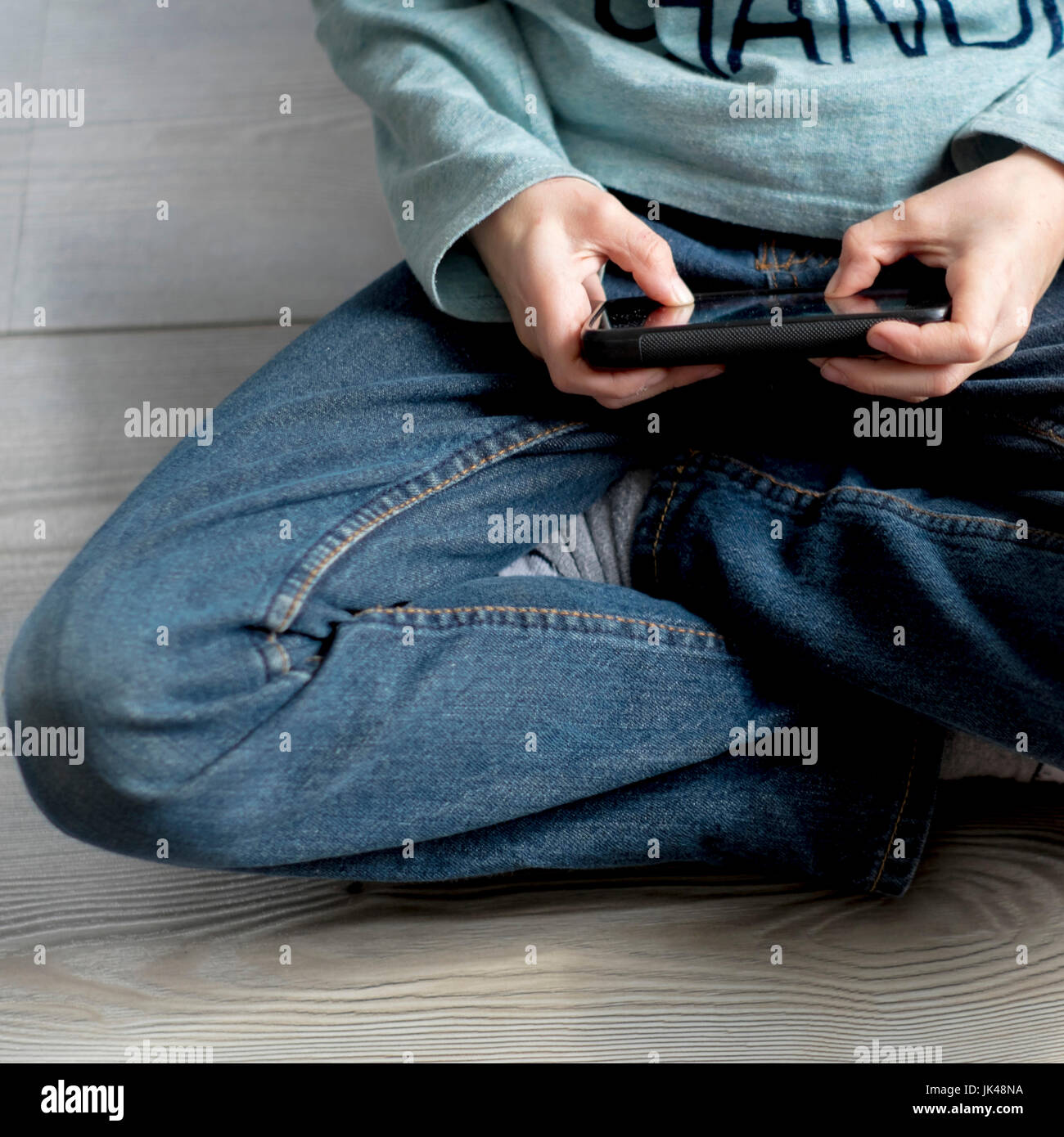 Close up of Caucasian boy playing with cell phone Stock Photo - Alamy