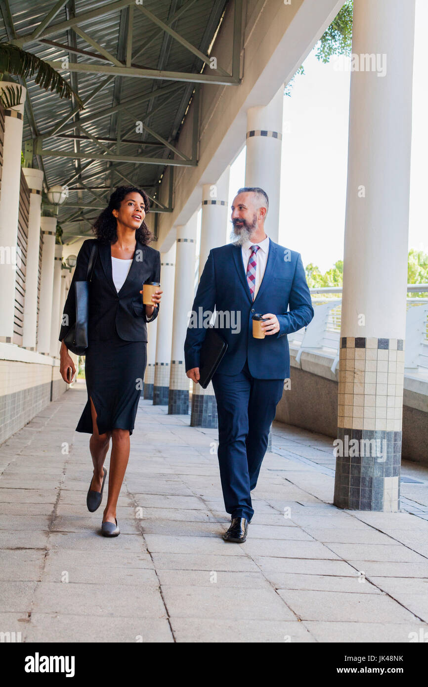 Business people walking on sidewalk Stock Photo - Alamy