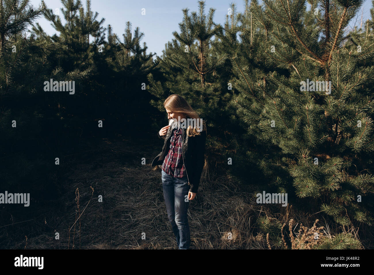 Woman standing in forest Stock Photo - Alamy