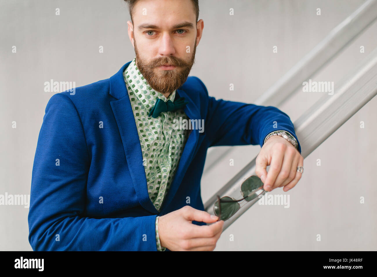 Stylish Middle Eastern man with beard holding sunglasses Stock Photo ...