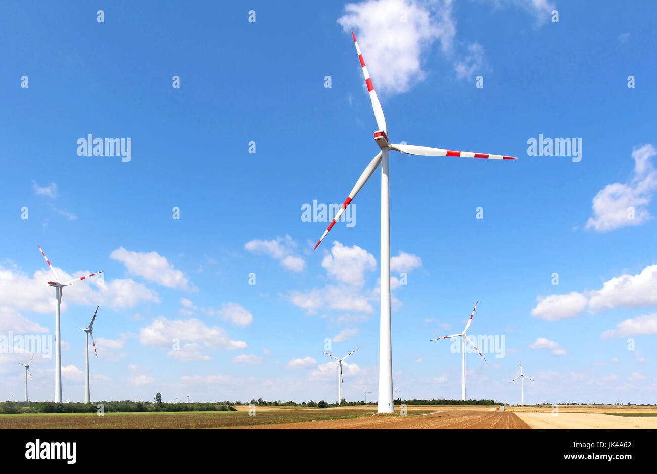 Windmill energy farm on large land field Stock Photo - Alamy