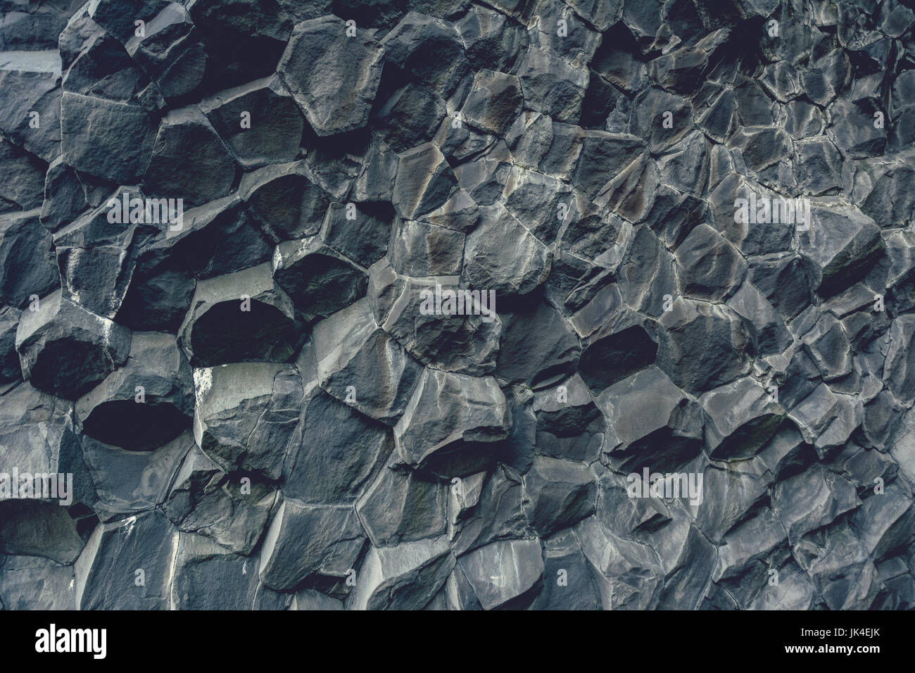 Basalt stone columns close-up on Reynisfjara black beach near Vik town ...