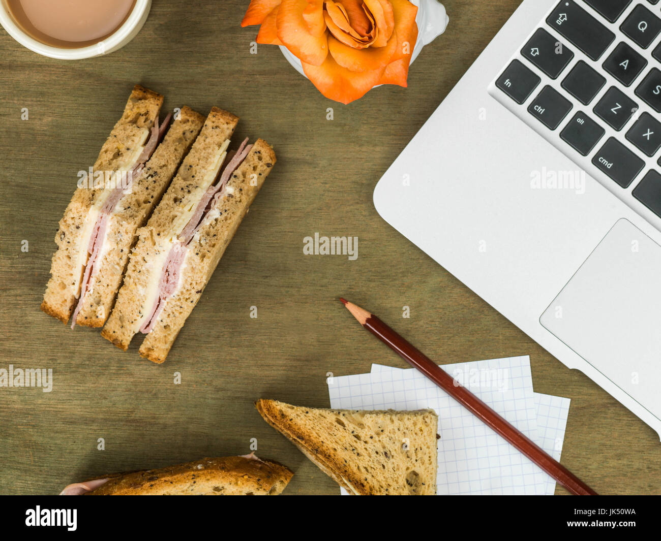 Ham and Cheese Sandwich in Brown Bread With a Cup of Tea At a Computer ...