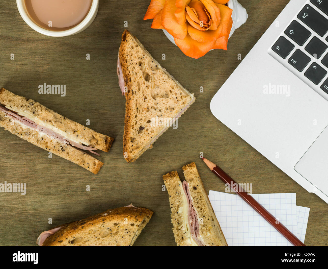 Ham and Cheese Sandwich in Brown Bread With a Cup of Tea At a Computer ...