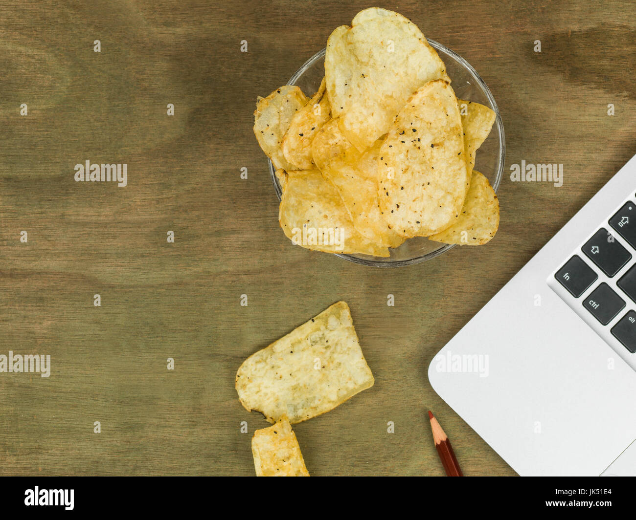 Computer Workstation With a Boewl of Potato Crisps or Potato Chips With ...