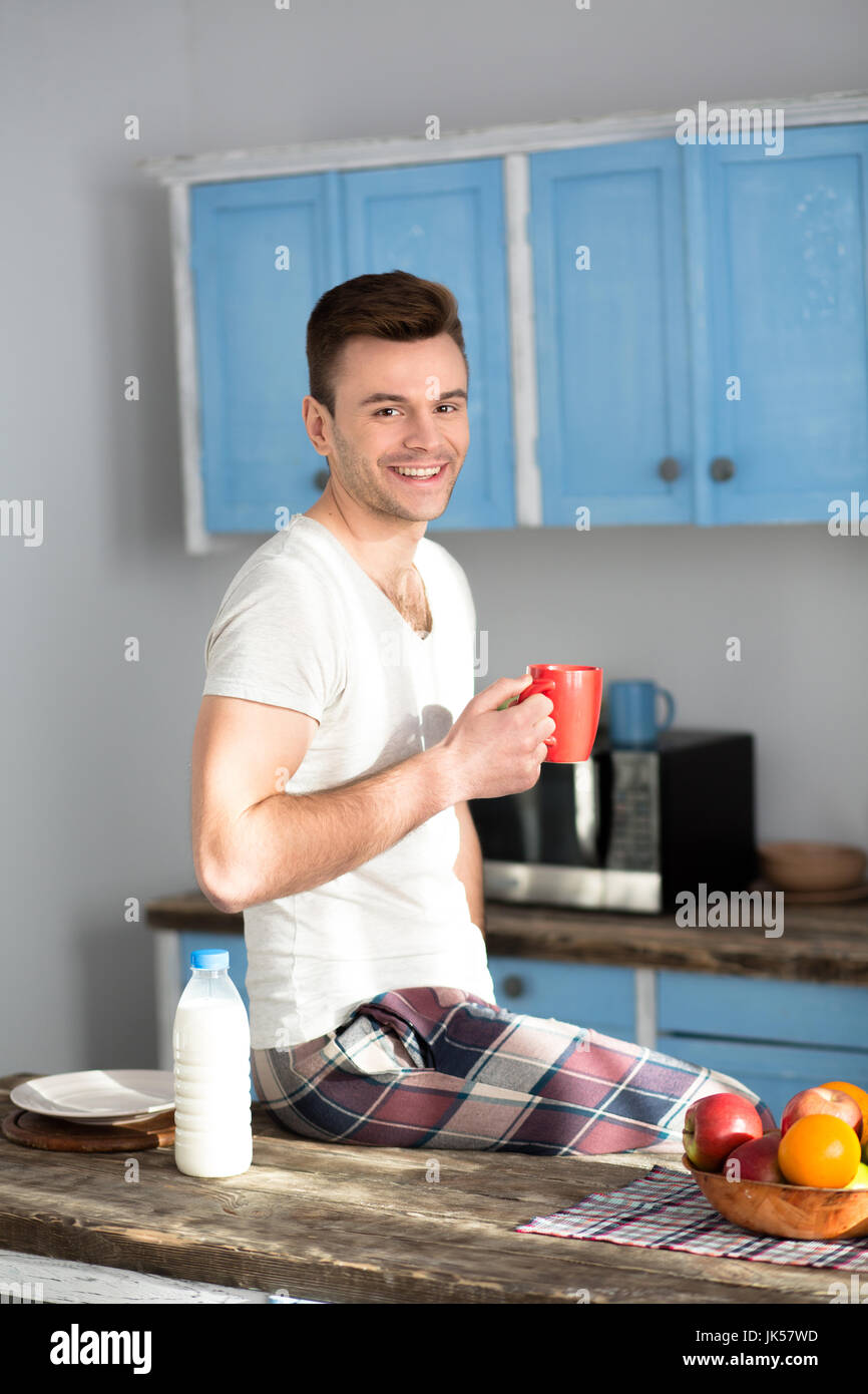 Happy young man at kitchen Stock Photo - Alamy