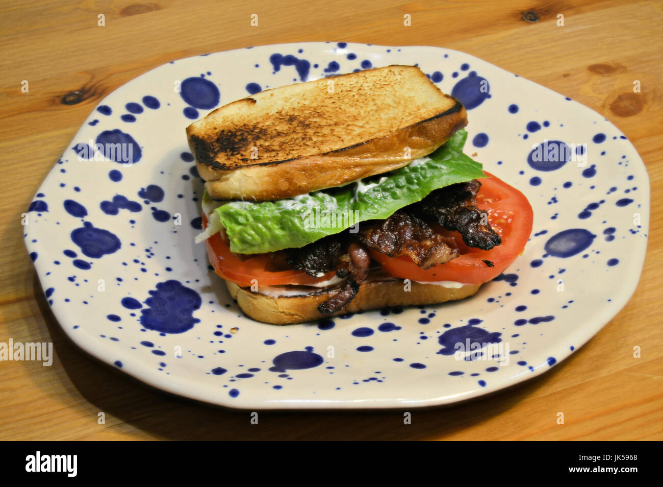 BLT Preparation Step 7 of 7 : but toasted toast on top of lettuce Stock ...