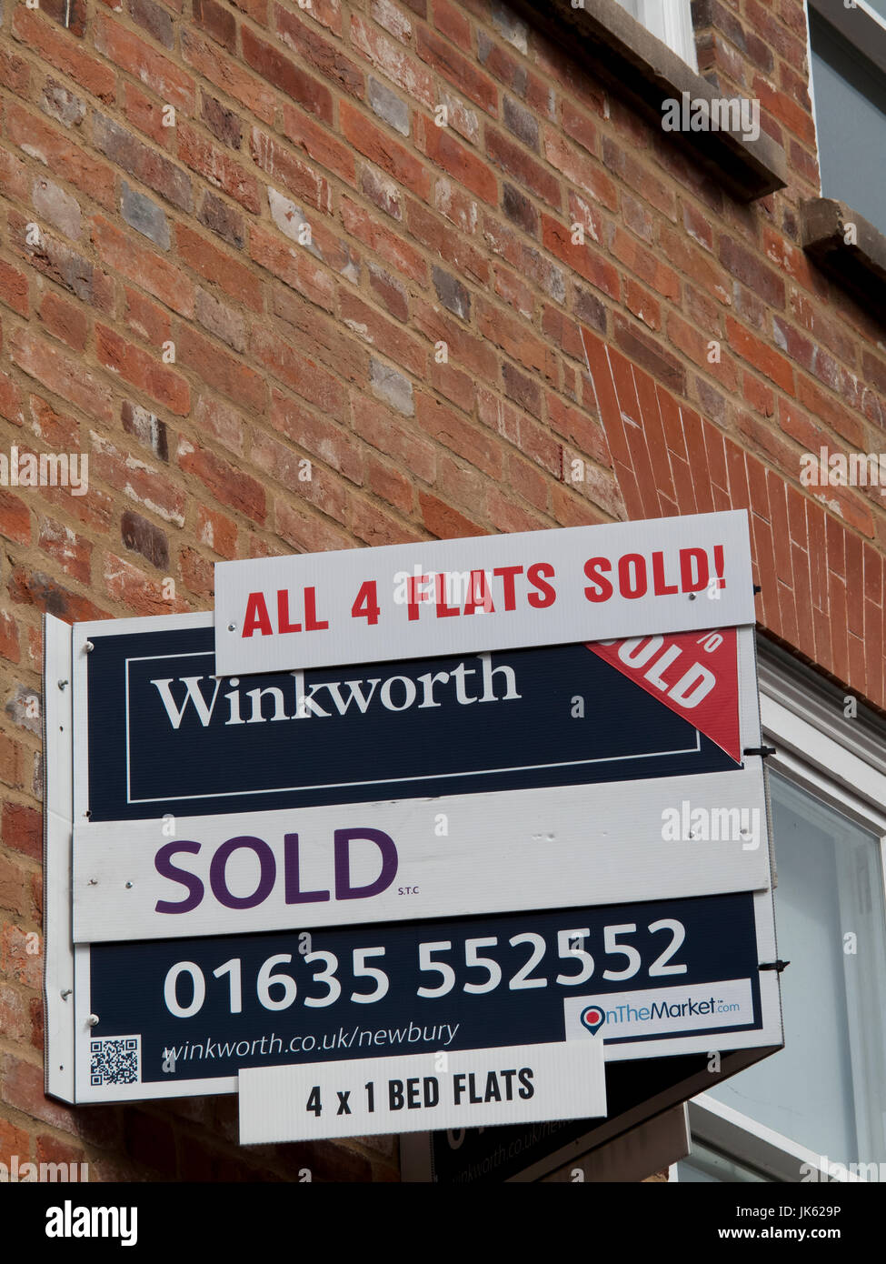 Estate Agent sign above properties showing all four residential flats ...