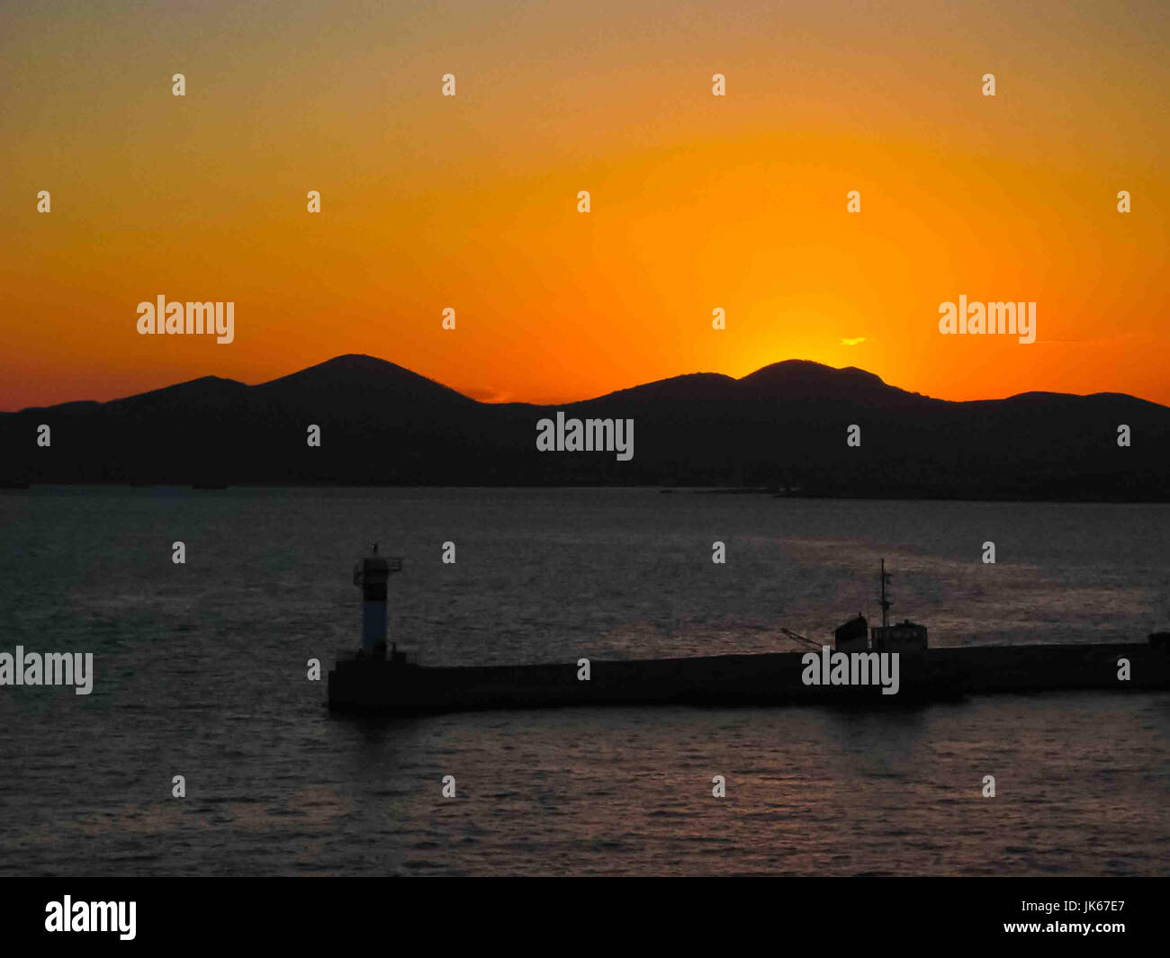 Piraeus, Greece. 30th Sep, 2004. A vividly colored sky on the horizon ...