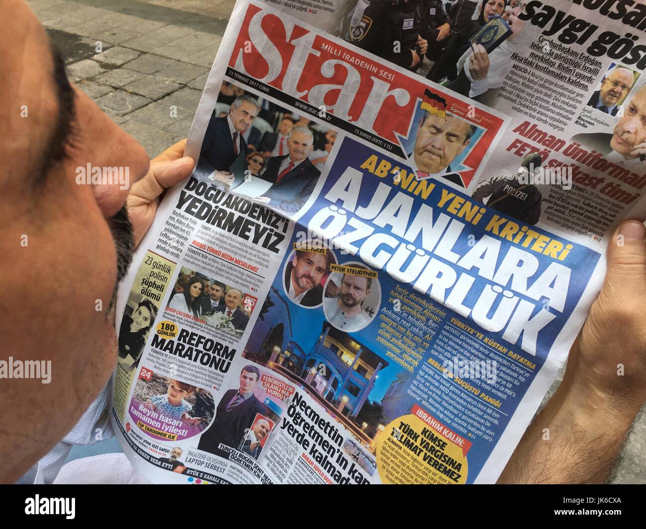 A man reads the popular Turkish newspaper 'Star' in Istanbul, Turkey ...