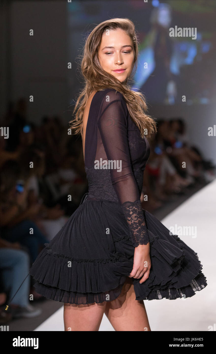 MIAMI BEACH, FL - JULY 21: A model walks the runway during the ...