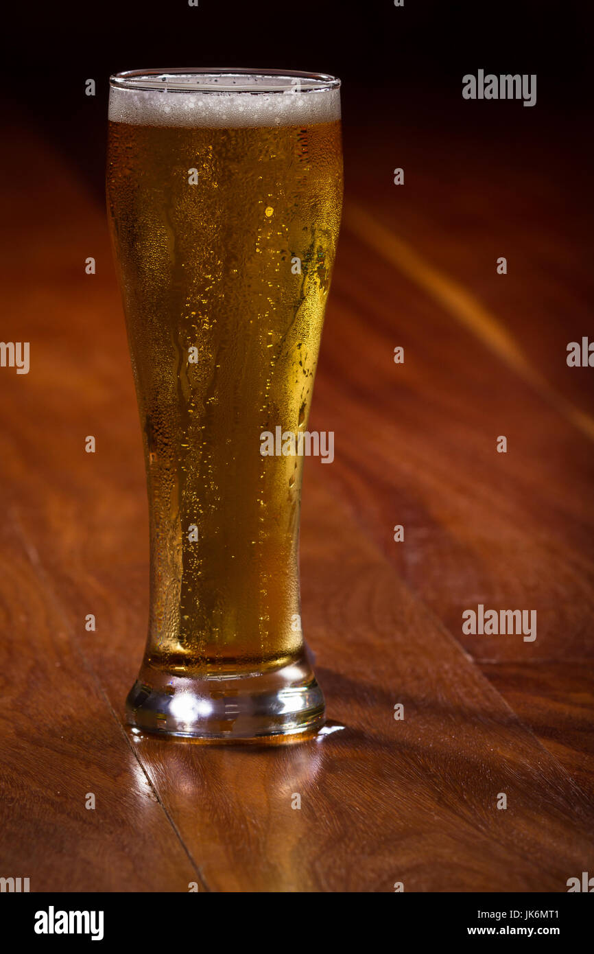 refreshing pint of golden ale beer served on a wooden counter Stock ...
