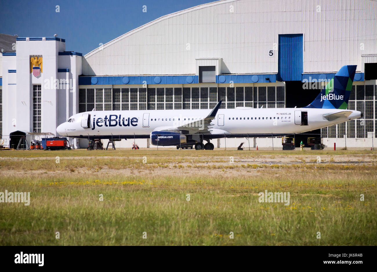 A jet Blue jet sitting outside a aircraft hangar Stock Photo - Alamy