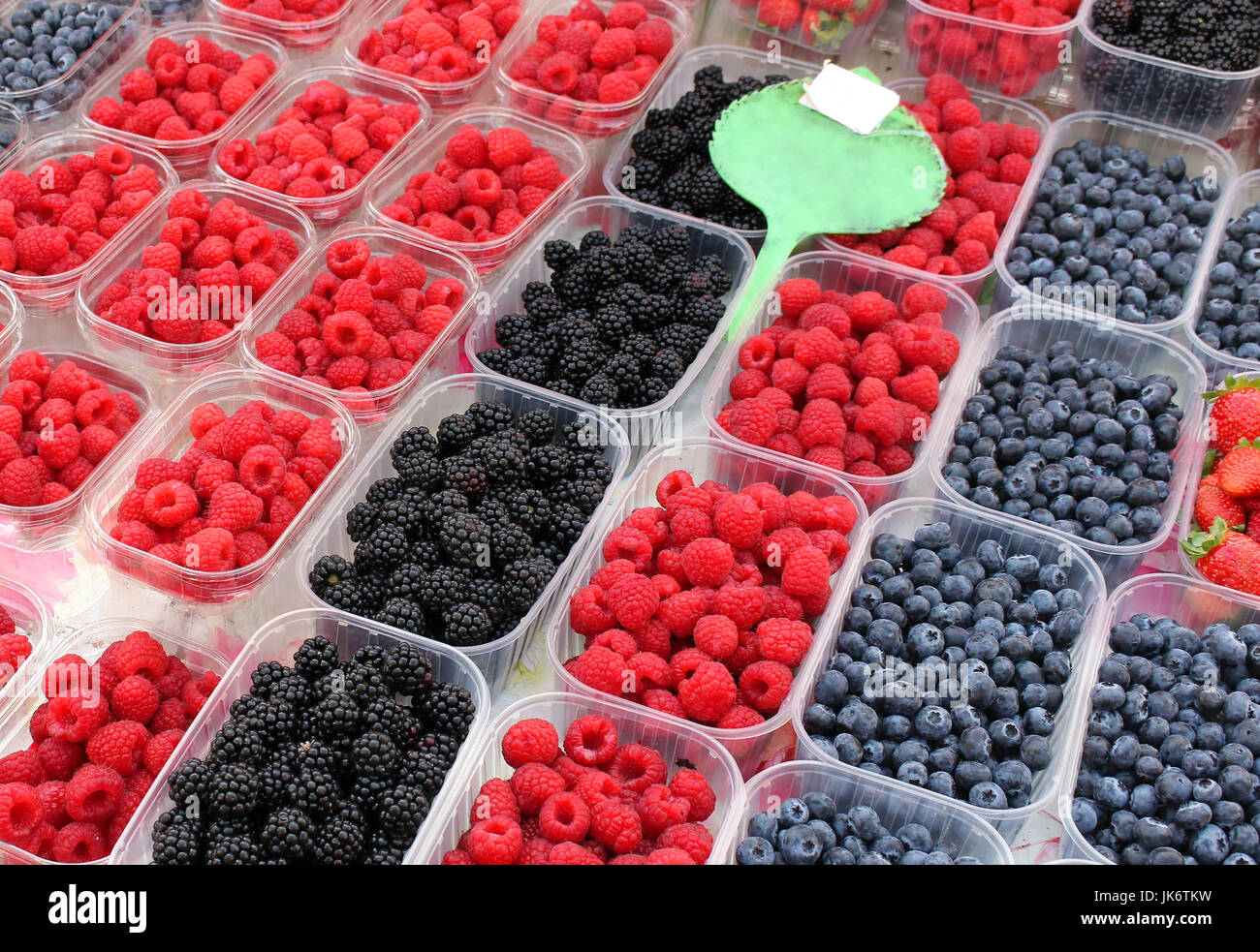 Fresh organic red berries fruits sold on market stall Stock Photo - Alamy