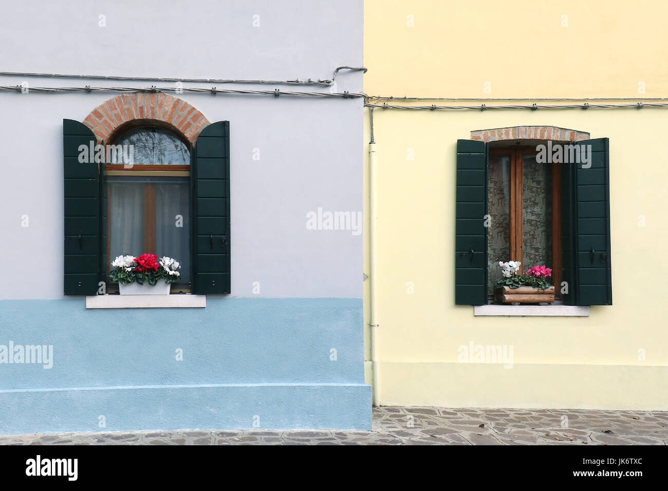 Open retro windows on colorful facades houses Stock Photo - Alamy