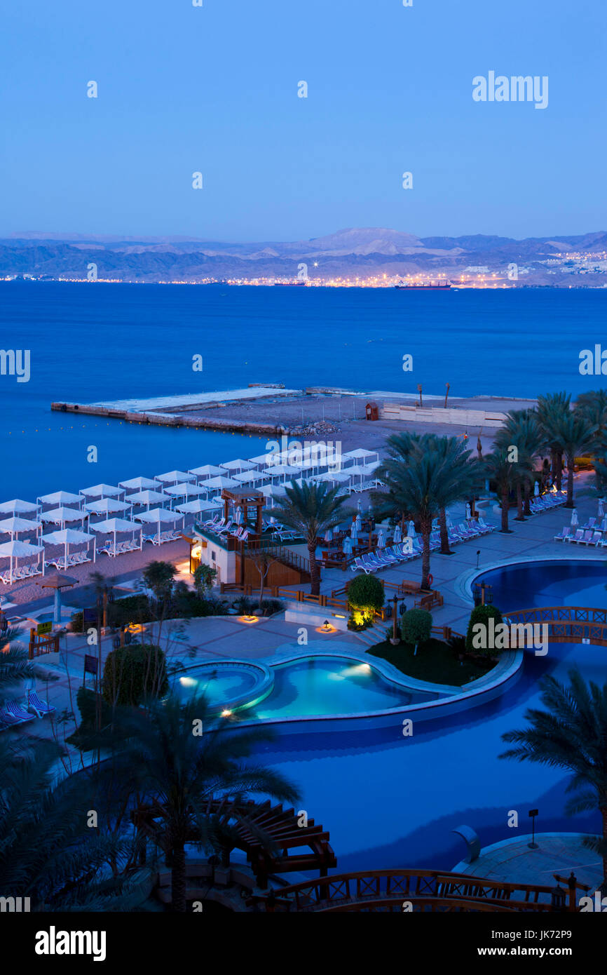 Jordan, Aqaba, elevated view over hotel swimming pool and Red Sea, dawn ...