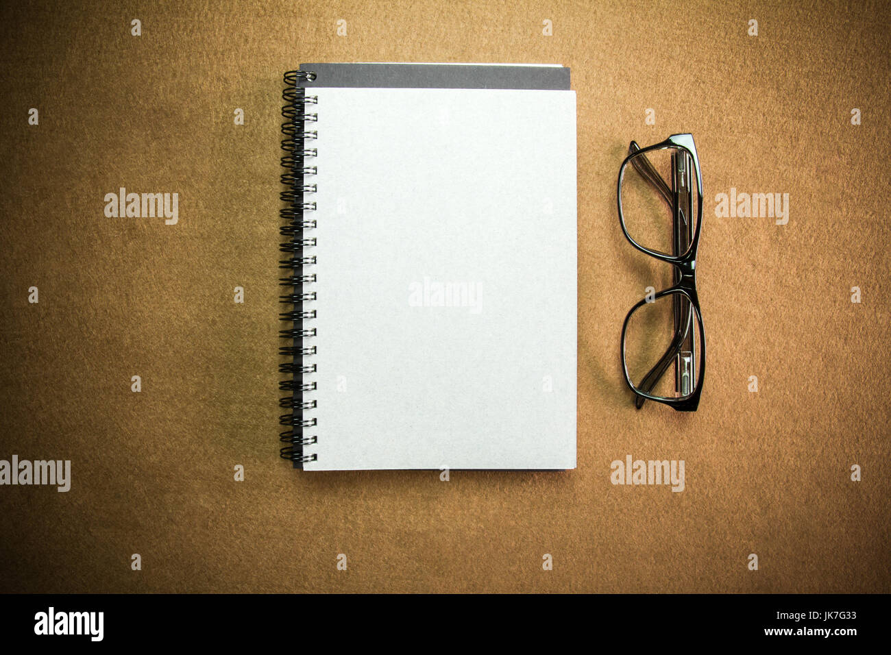 Notebook and glasses with vignette Stock Photo - Alamy
