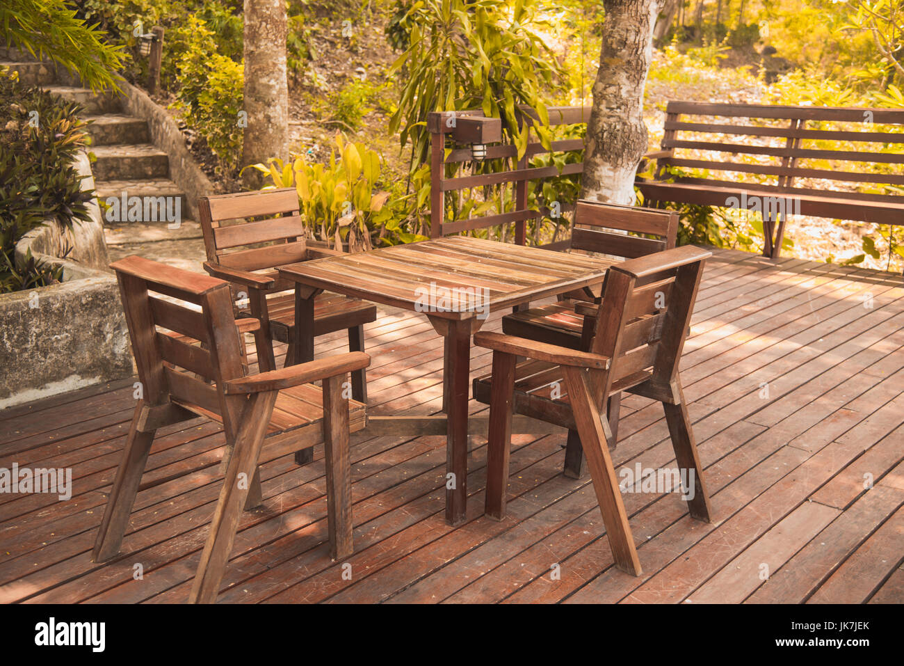 Table corner on wooden terrace, vintage solid wood furniture with ...