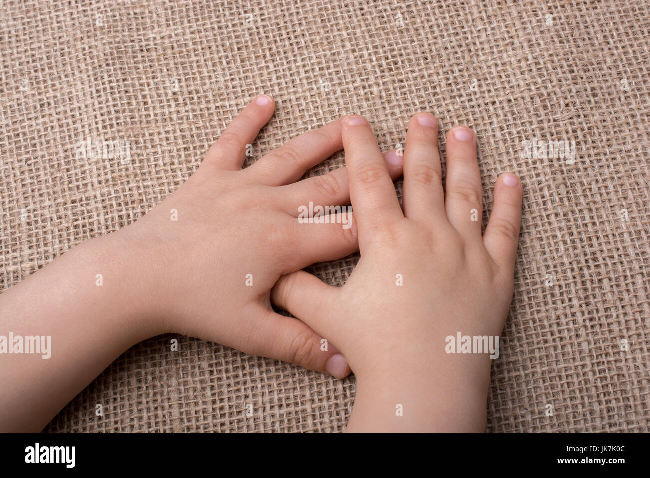 Toddler hand with canvas linen background Stock Photo - Alamy
