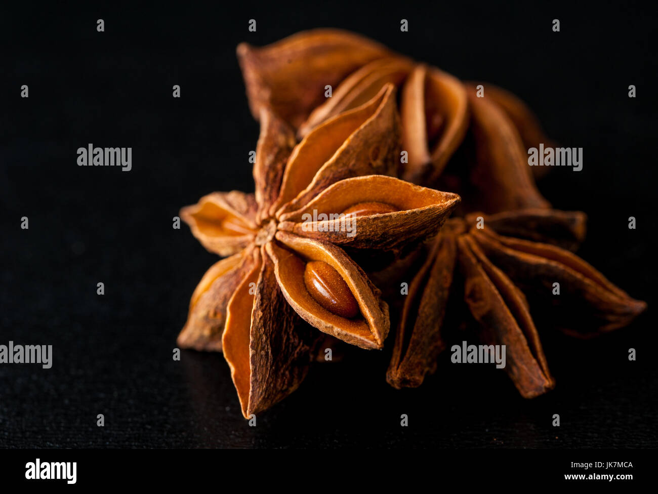 Anise stars on dark background Stock Photo - Alamy