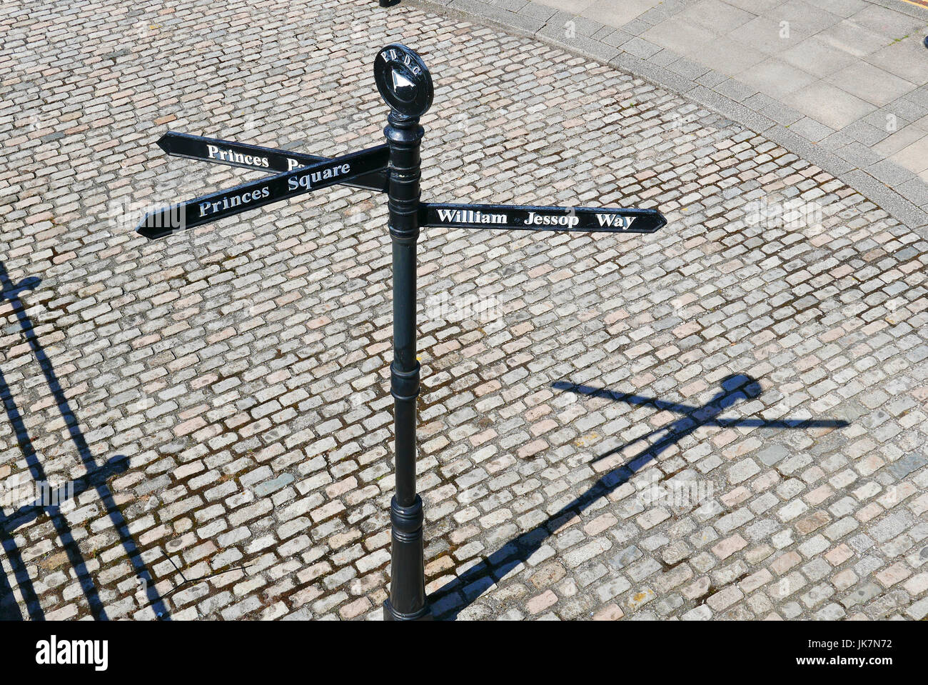 Ornate iron sign post set against brick paving stones on William Jessop ...