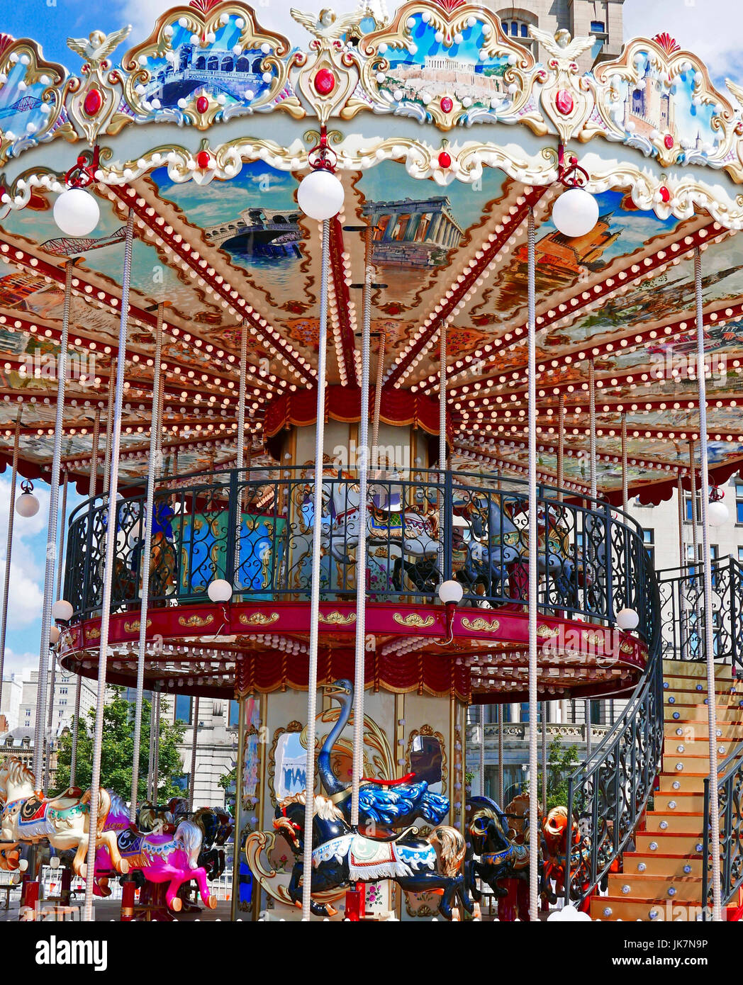 Ornate double level merry go round at the funfair on Pier Head Village ...