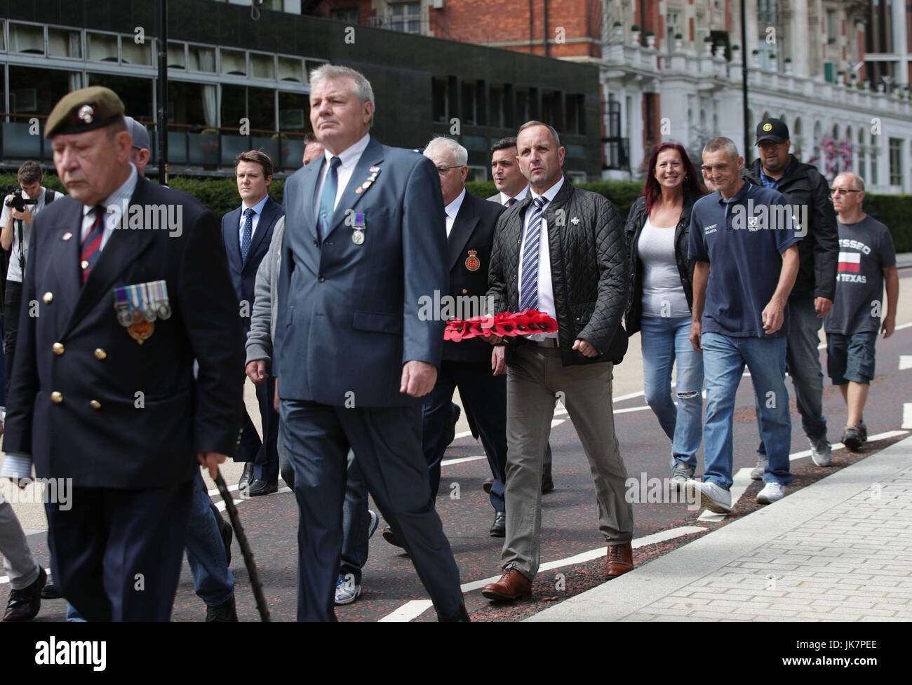 Mark Tipper (centre, holding wreath), whose 19-year-old brother Simon ...