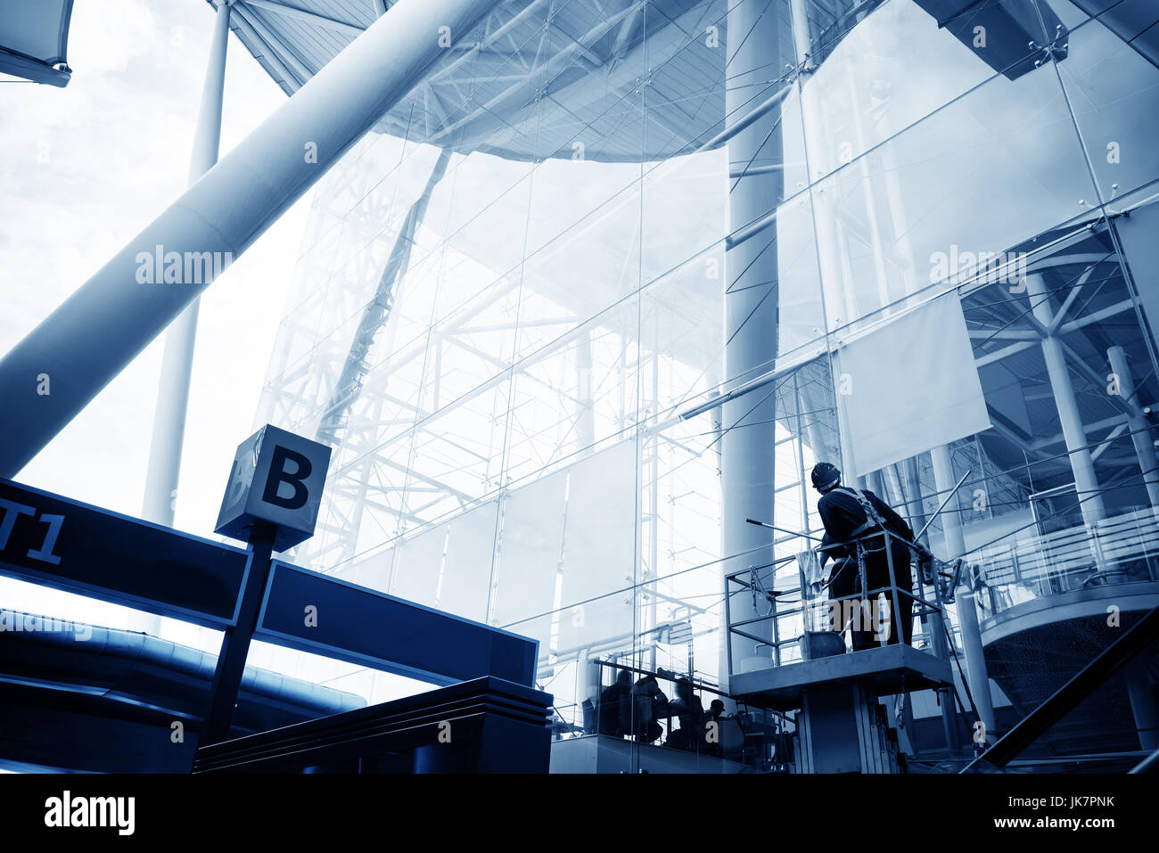 The walls of modern airports, workers are cleaning glass curtain walls ...