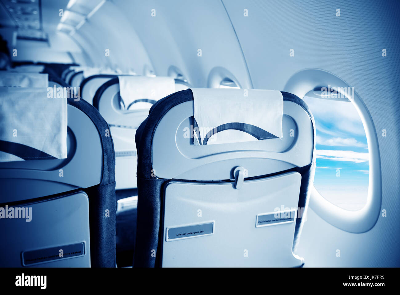 Empty aircraft seats and windows,Blue tone map Stock Photo - Alamy