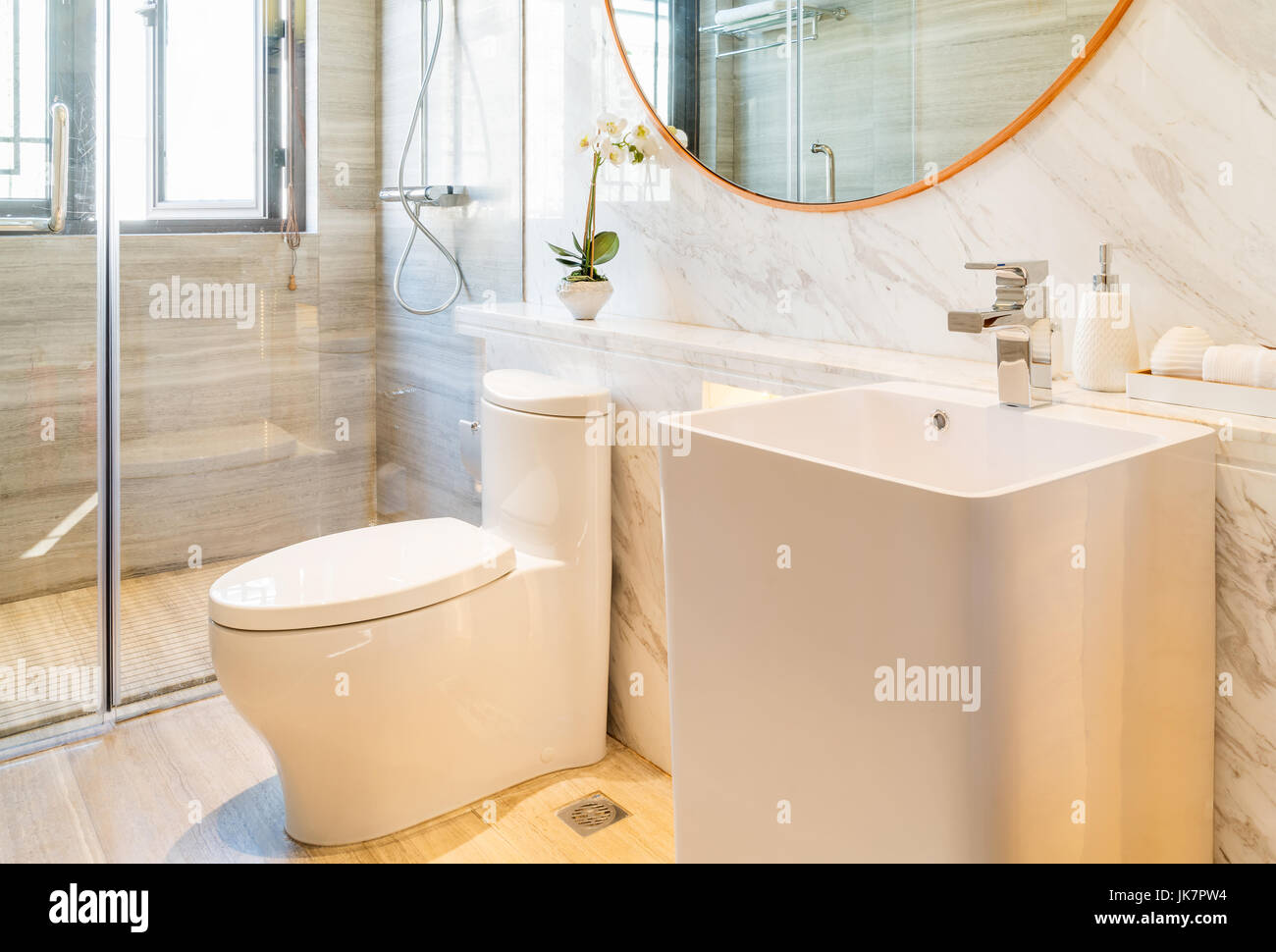 Clean and bright bathroom, washbasin and toilet Stock Photo - Alamy