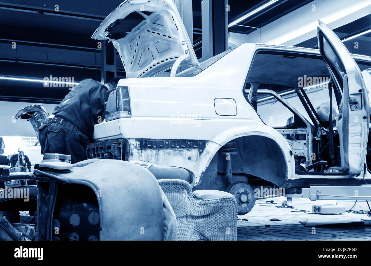 The technician is repairing the car, the blue hue Stock Photo - Alamy