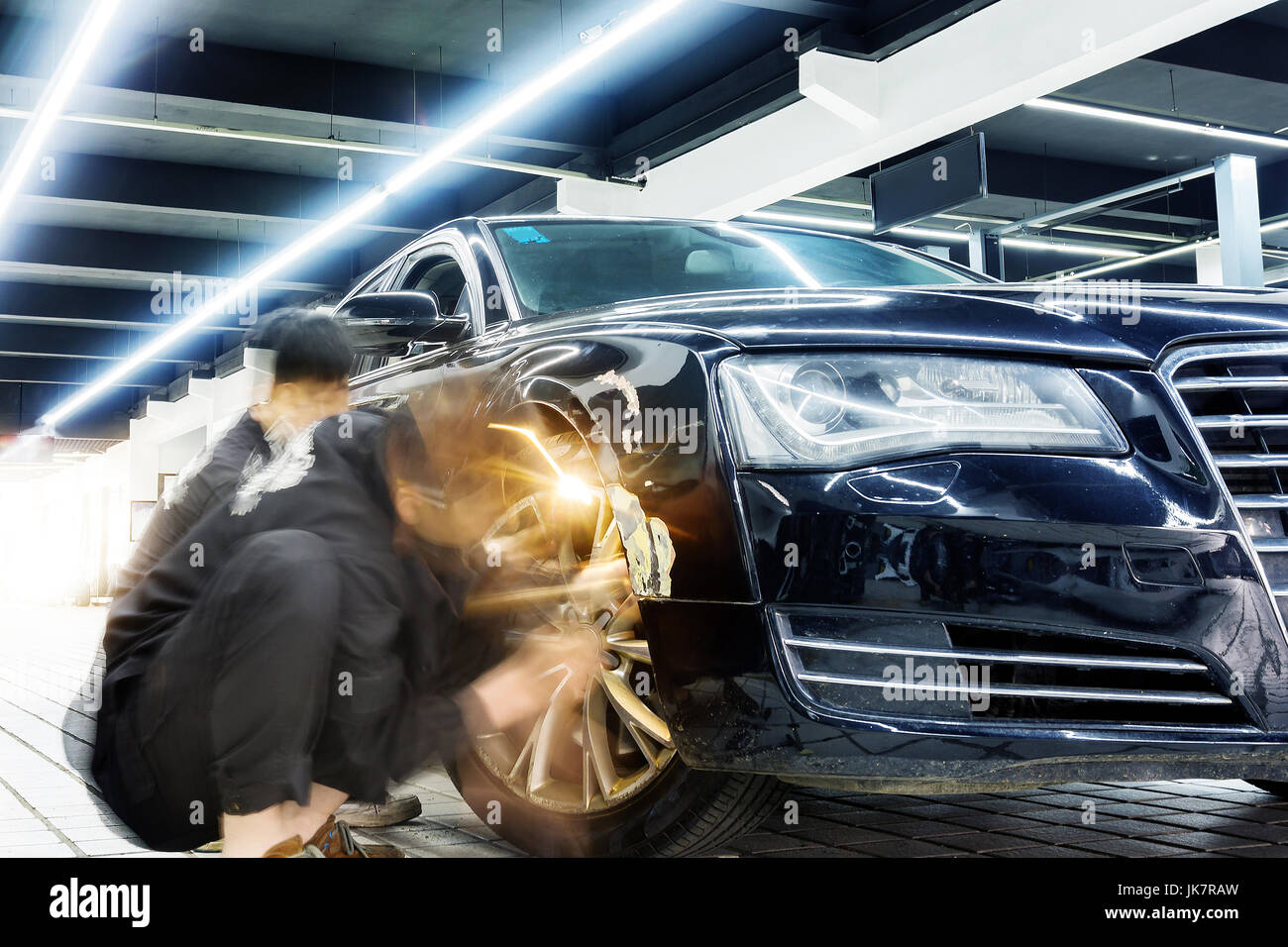 The technician is repairing the car, the blue hue Stock Photo - Alamy