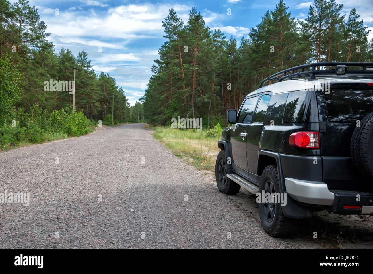 Car in the forest road Stock Photo - Alamy