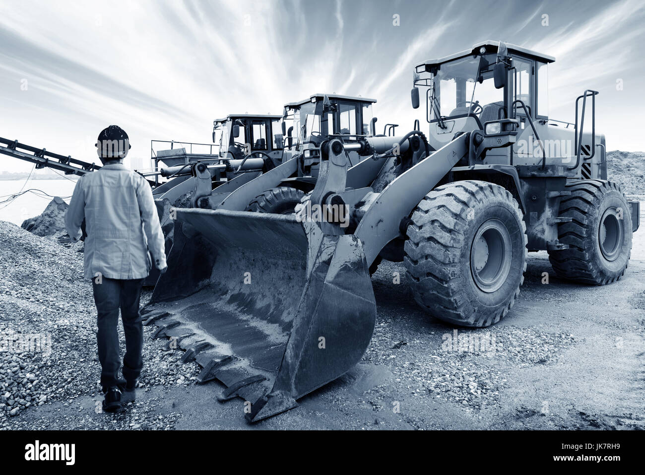 Construction site, workers are moving to the excavator Stock Photo - Alamy
