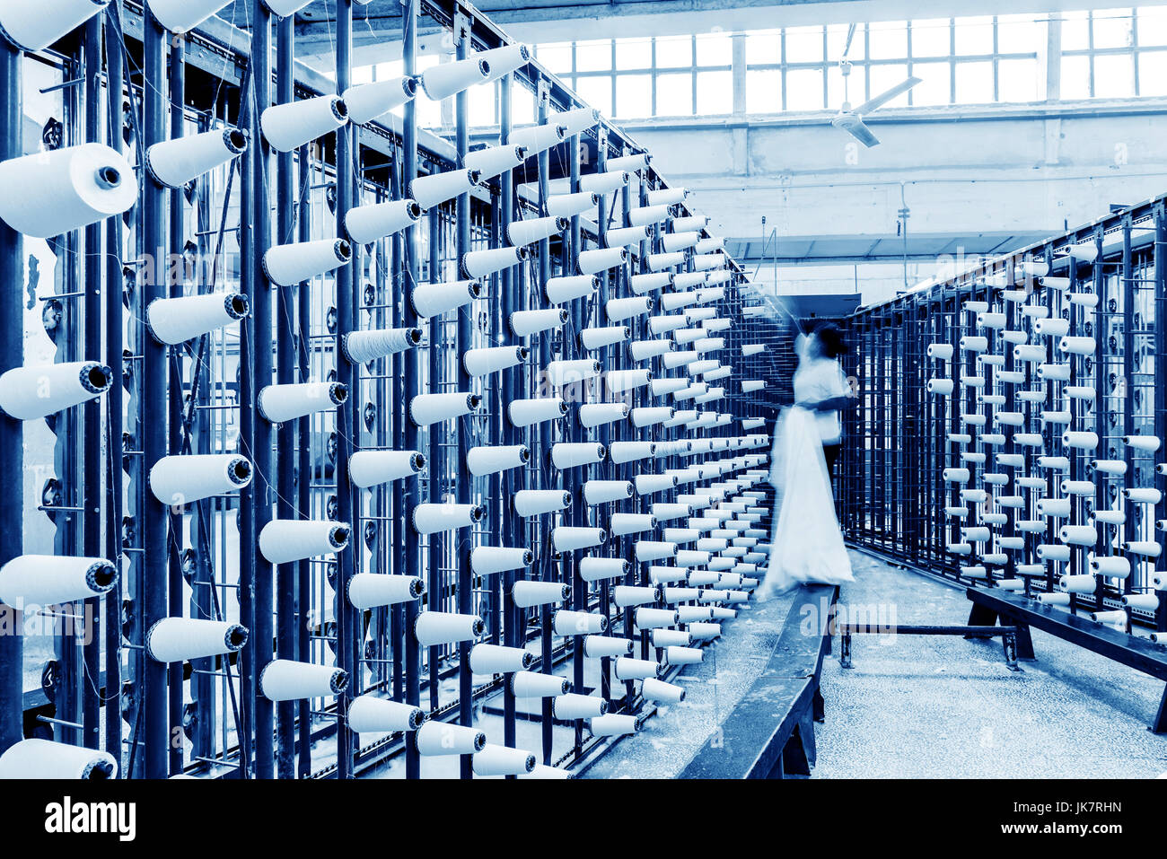 large group of bobbin thread cones on a warping machine in a textile ...