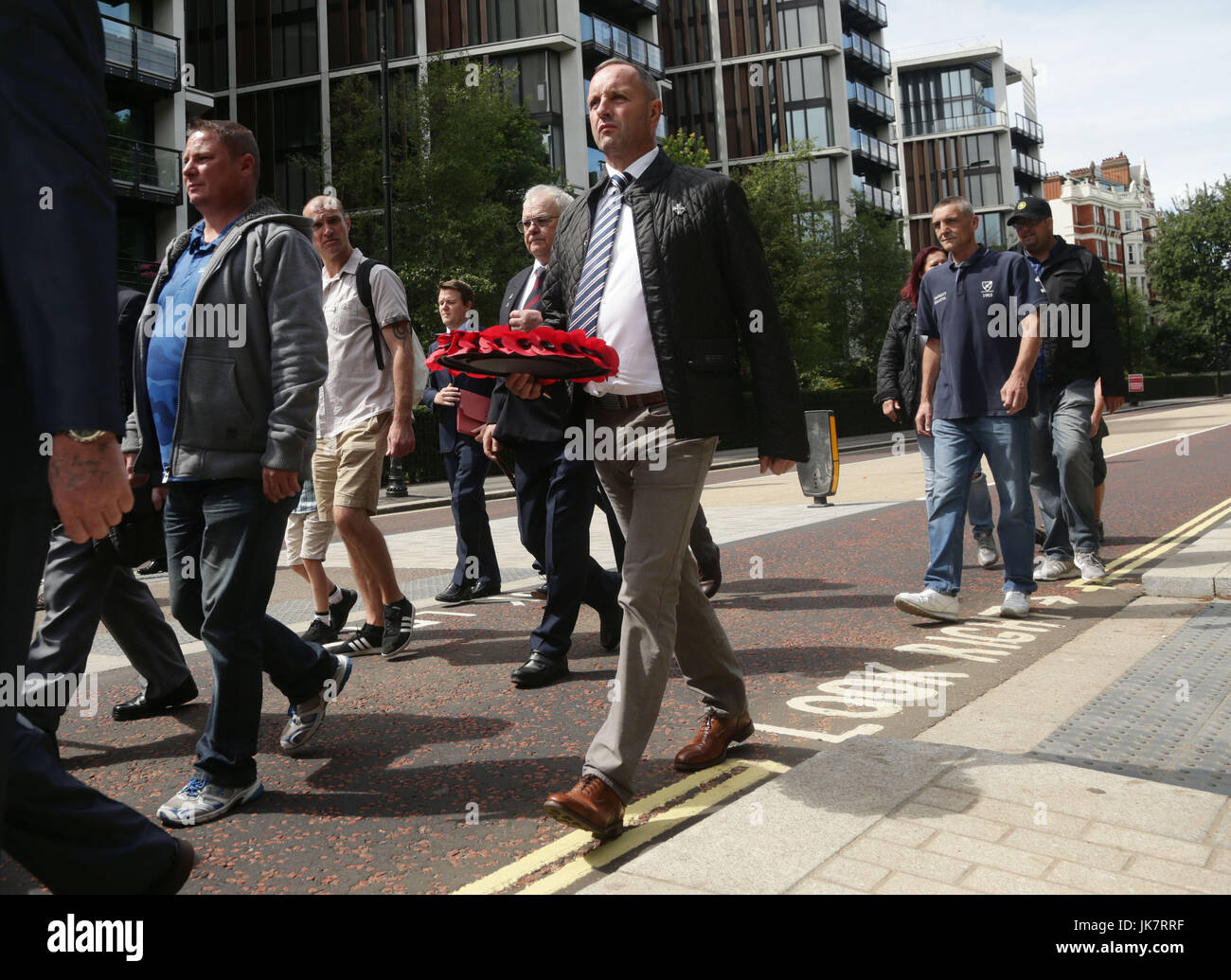 Mark Tipper (centre, holding wreath), whose 19-year-old brother Simon ...